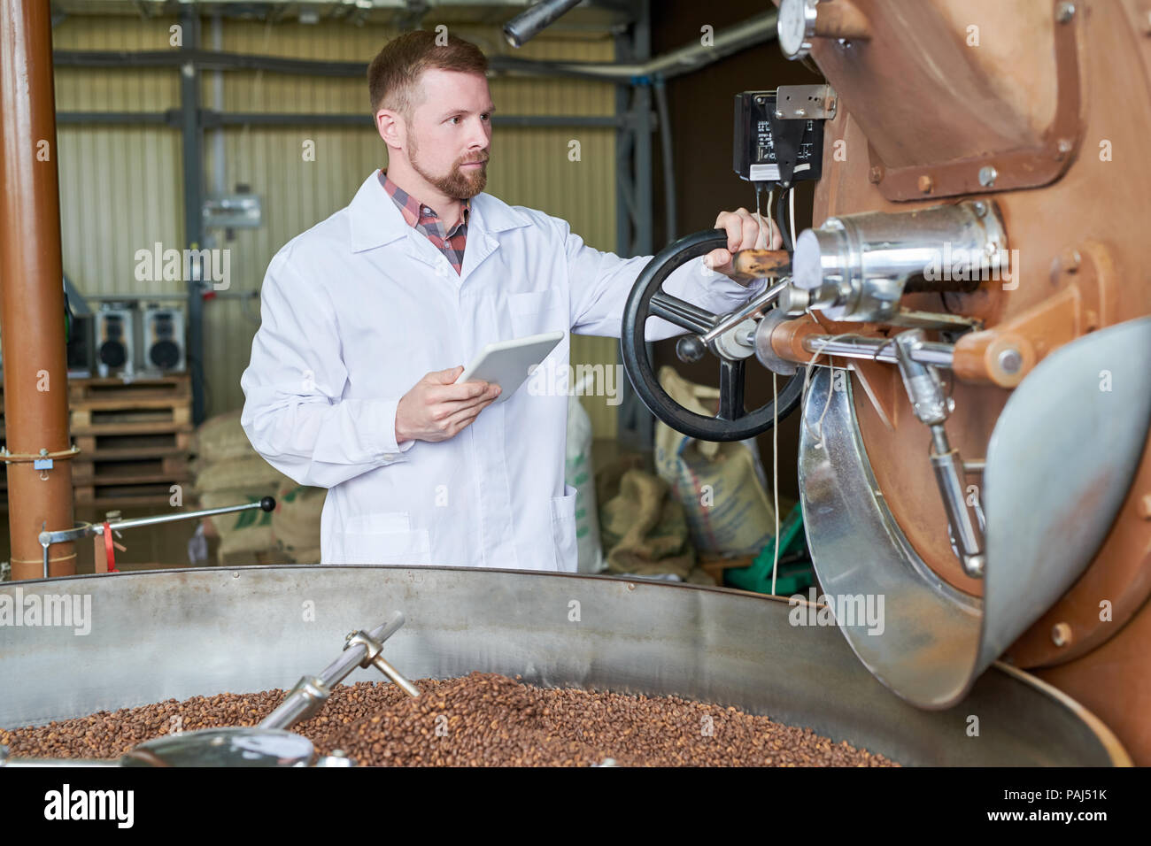 Worker Roasting Coffee Stock Photo - Alamy