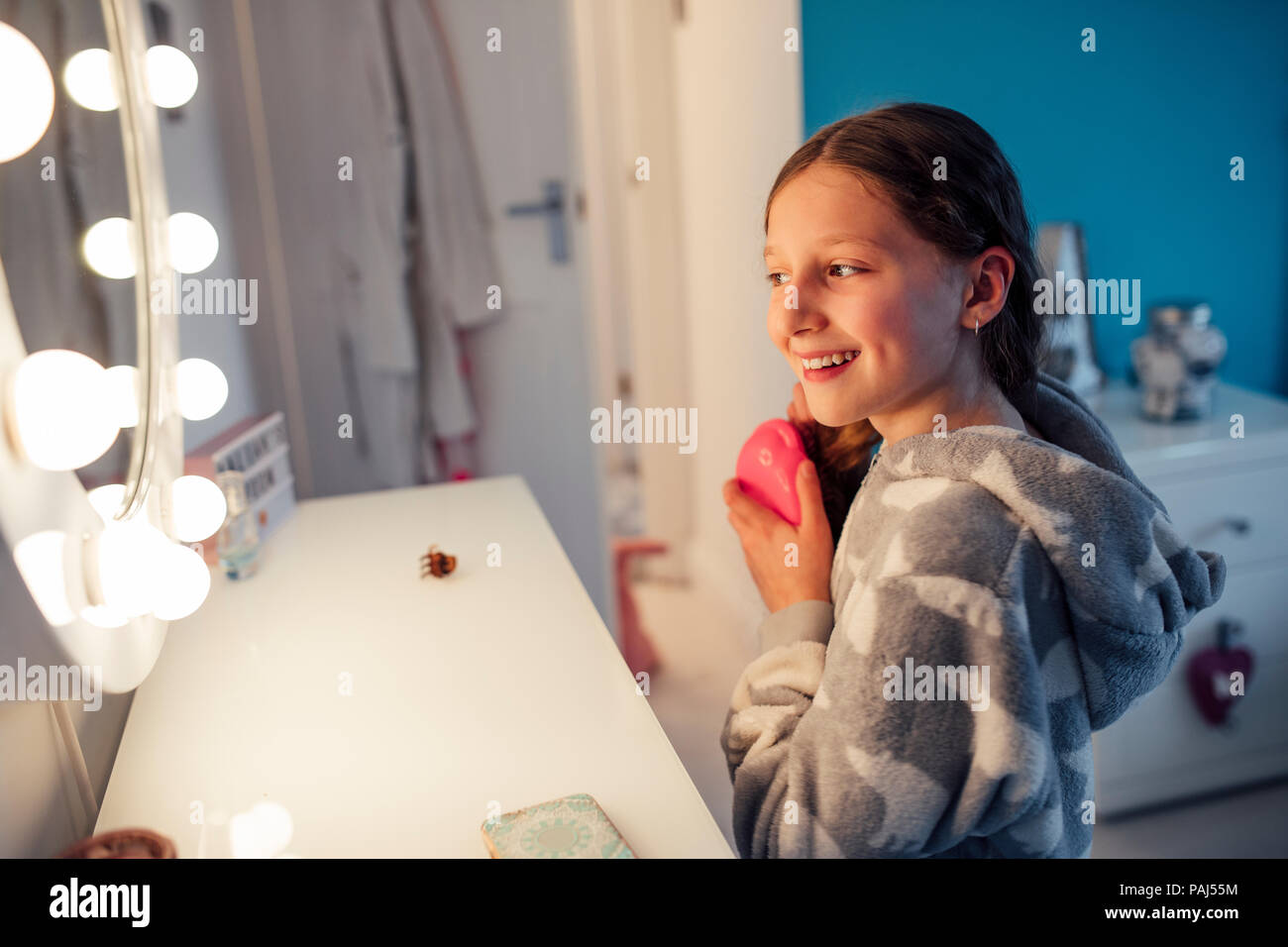 Little girl is brushing her hair at the mirror in her bedroom Stock ...