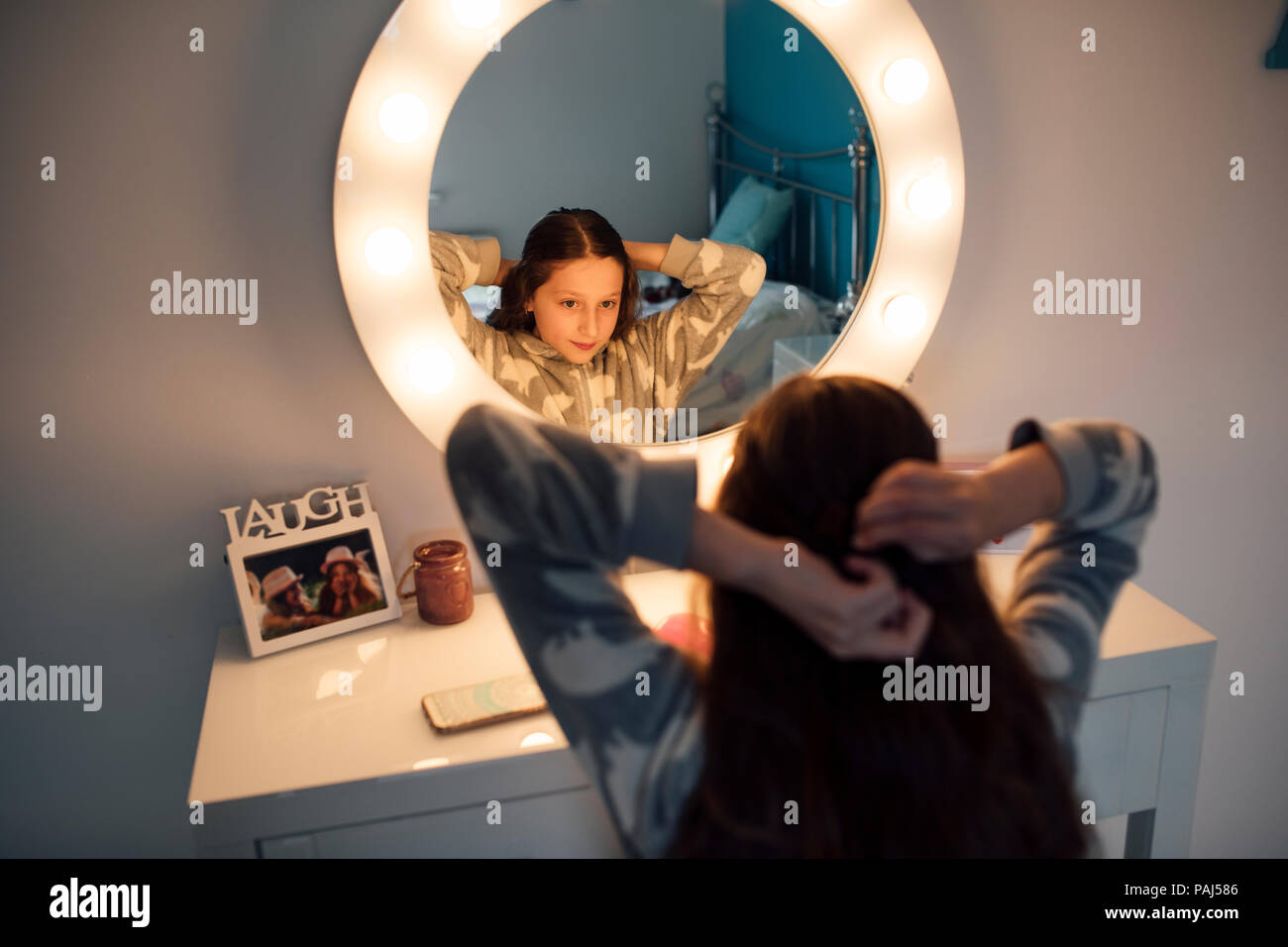 Little girl is brushing her hair at the mirror in her bedroom Stock ...