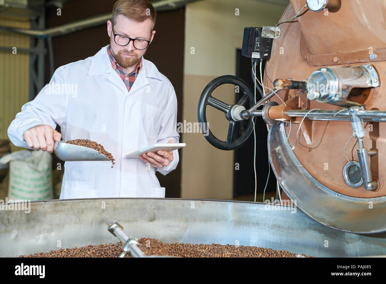 Worker Checking Quality of Coffee Roast Stock Photo - Alamy