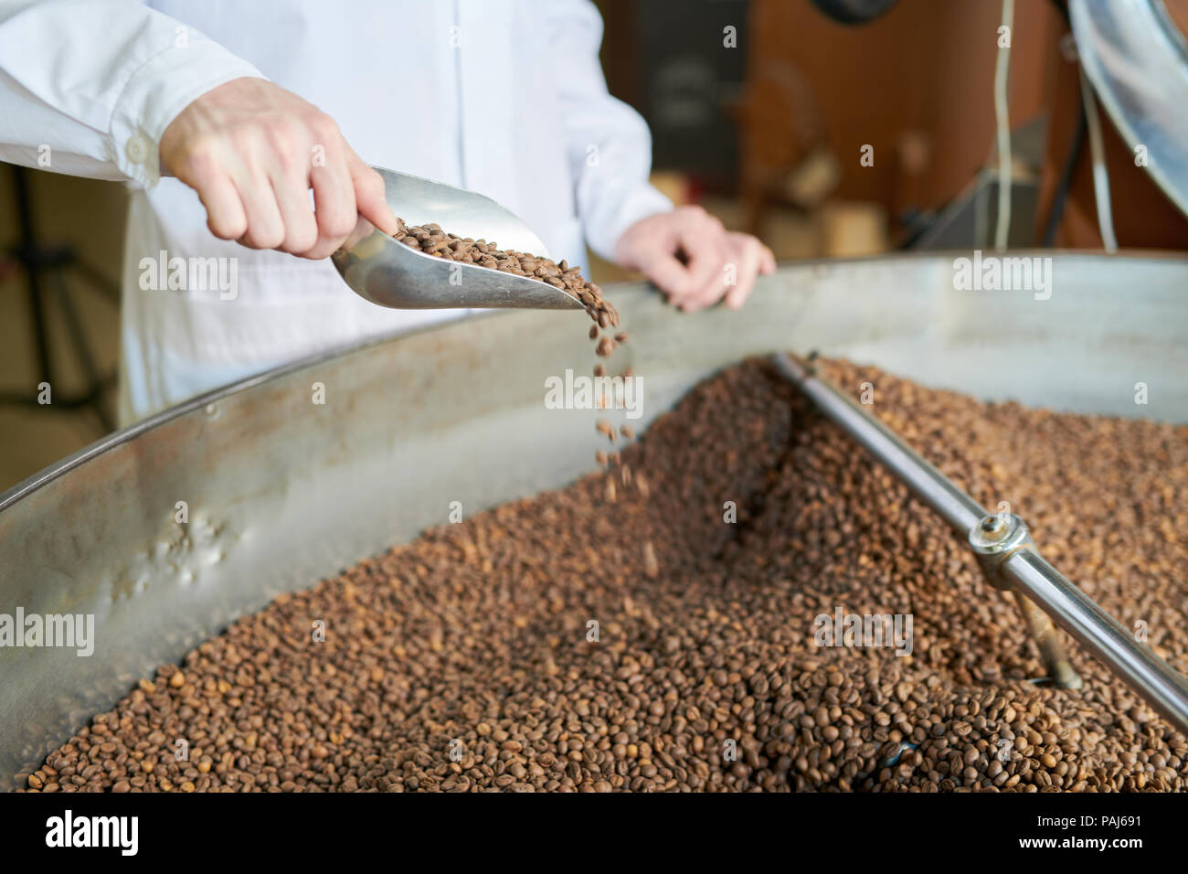 Worker Checking Roasting Process at Factory Stock Photo - Alamy