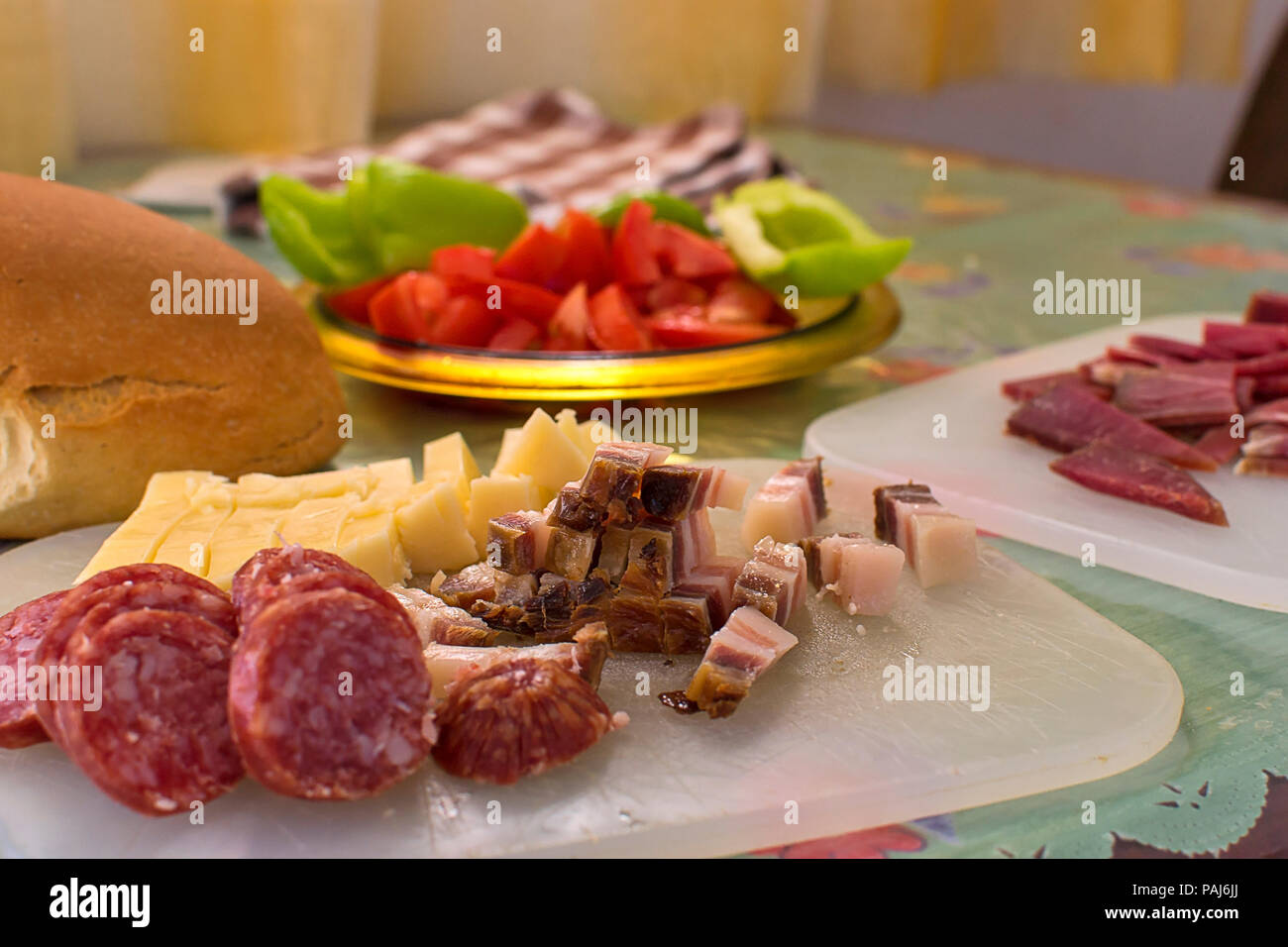 Serbian breakfast with sliced domestic sausage, bacon, ham and cheese ...