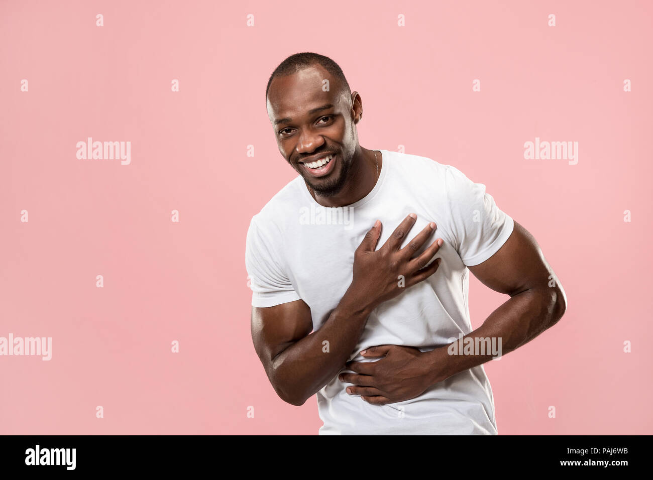 The happy business man standing and smiling Stock Photo - Alamy