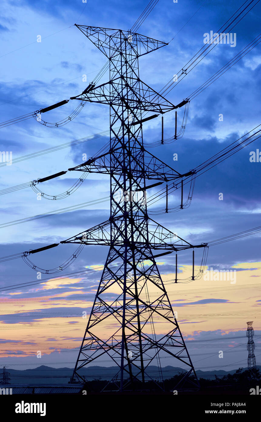 High voltage electricity pylon against blue sky Stock Photo - Alamy