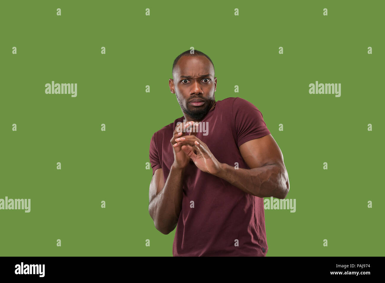 Portrait of the scared man on green Stock Photo - Alamy
