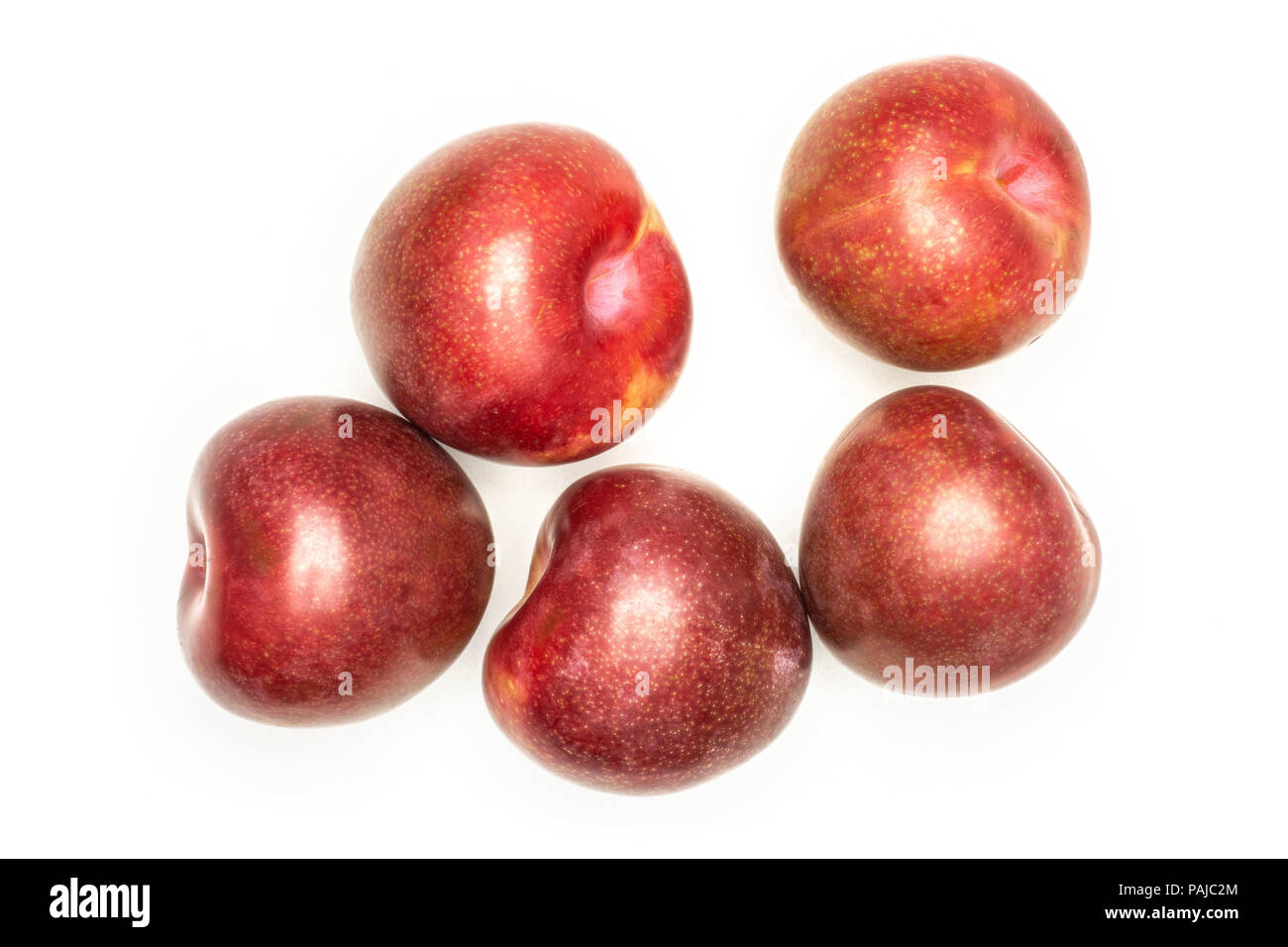 Group of five whole fresh pluot interspecific plums variety flatlay ...