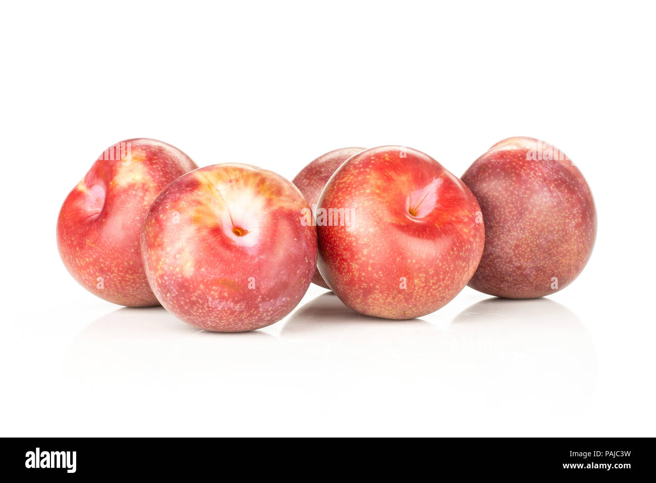 Lot of whole fresh pluot interspecific plums variety isolated on white ...