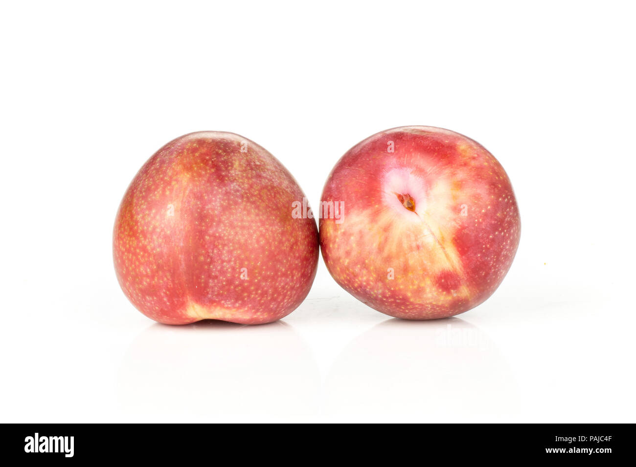 Group of two whole fresh pluot interspecific plums variety isolated on ...