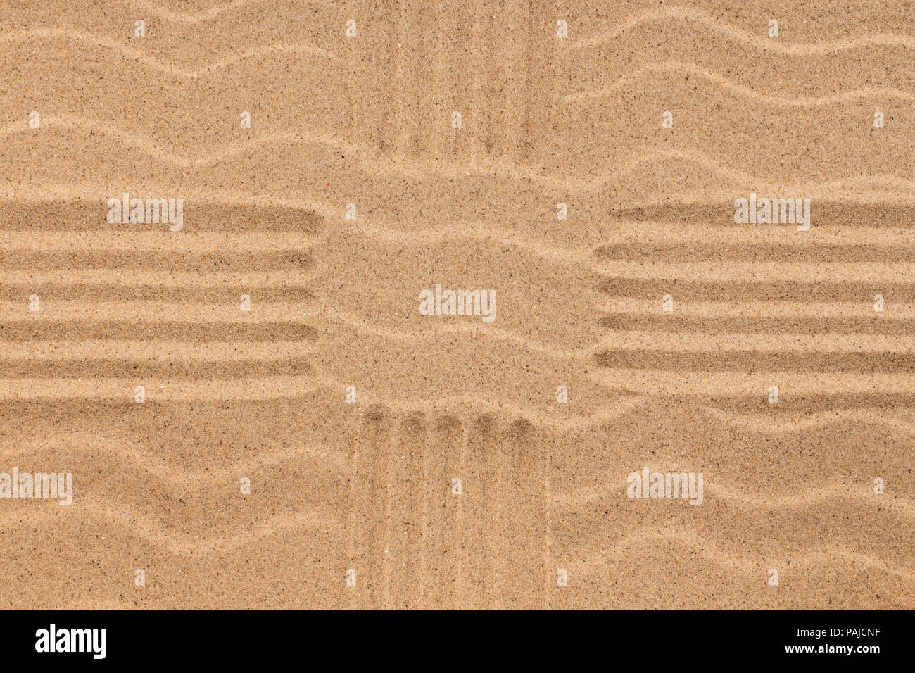 Texture of sand with lines in the form of a cross. View from above ...