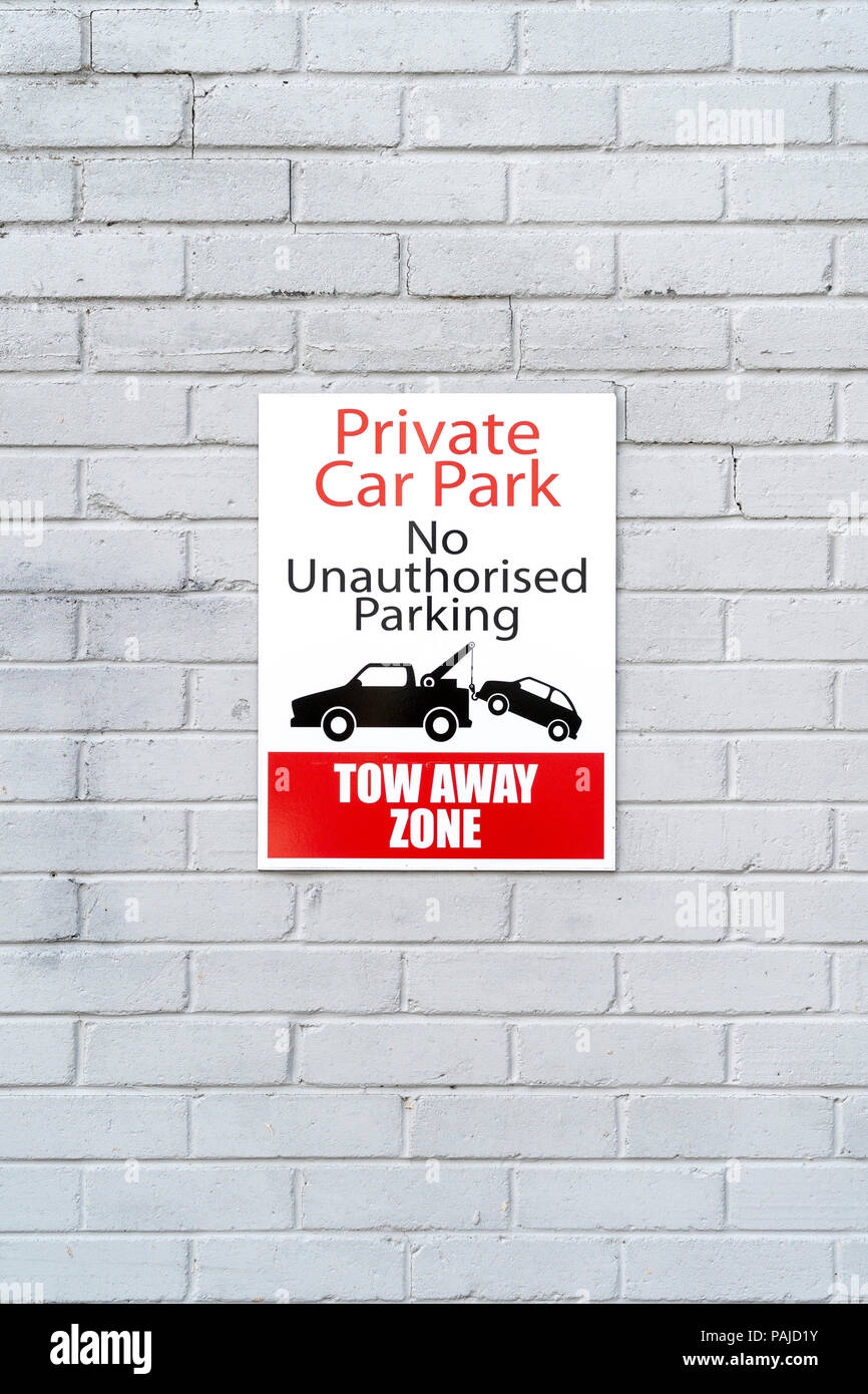 Private car park sign on grey brick wall Stock Photo - Alamy