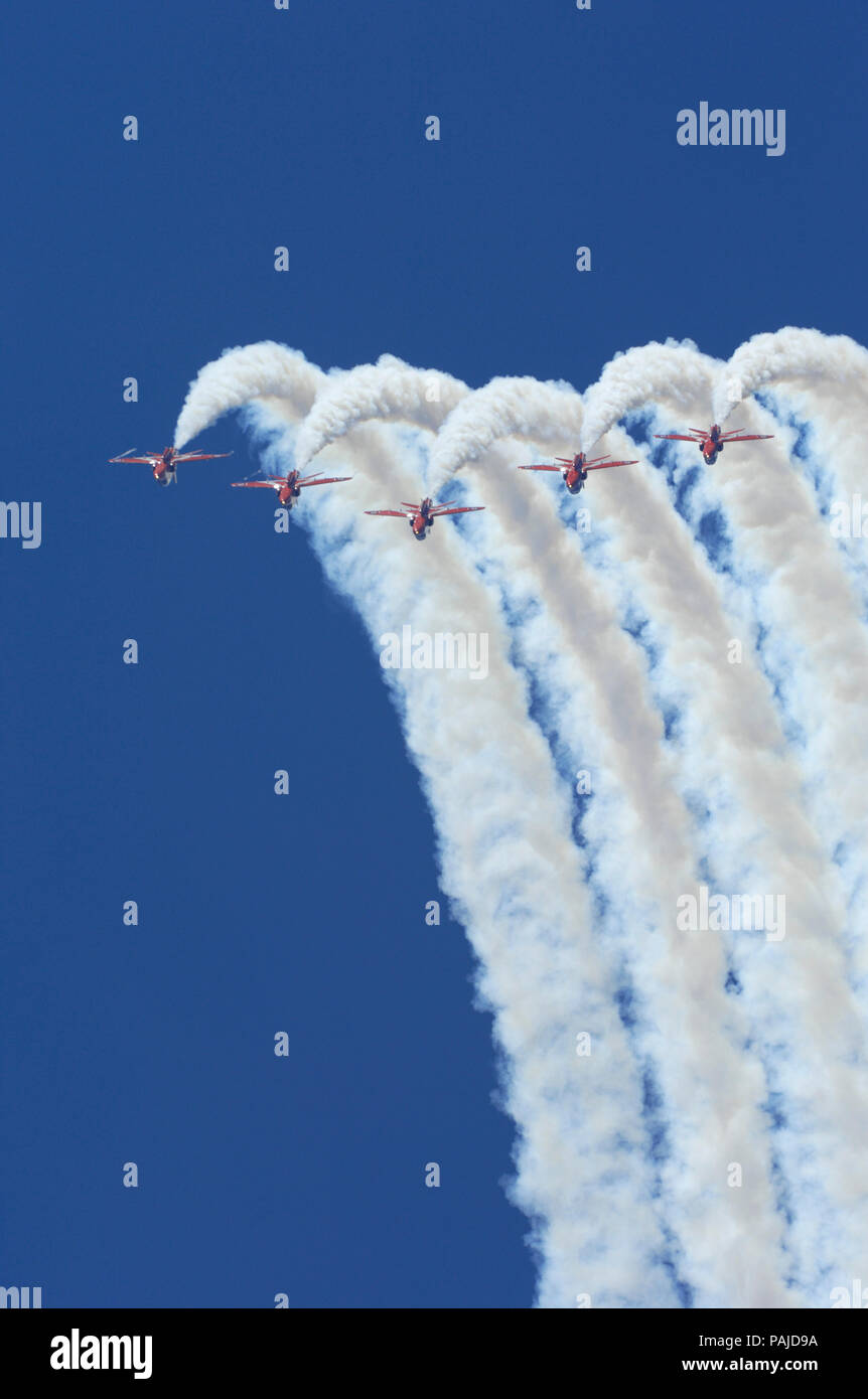 Red Arrows formation aerobatics team flying over the top of a loop ...