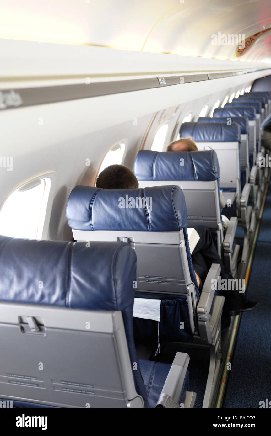 passengers sitting in the economy-class cabin seats of Embraer ERJ ...