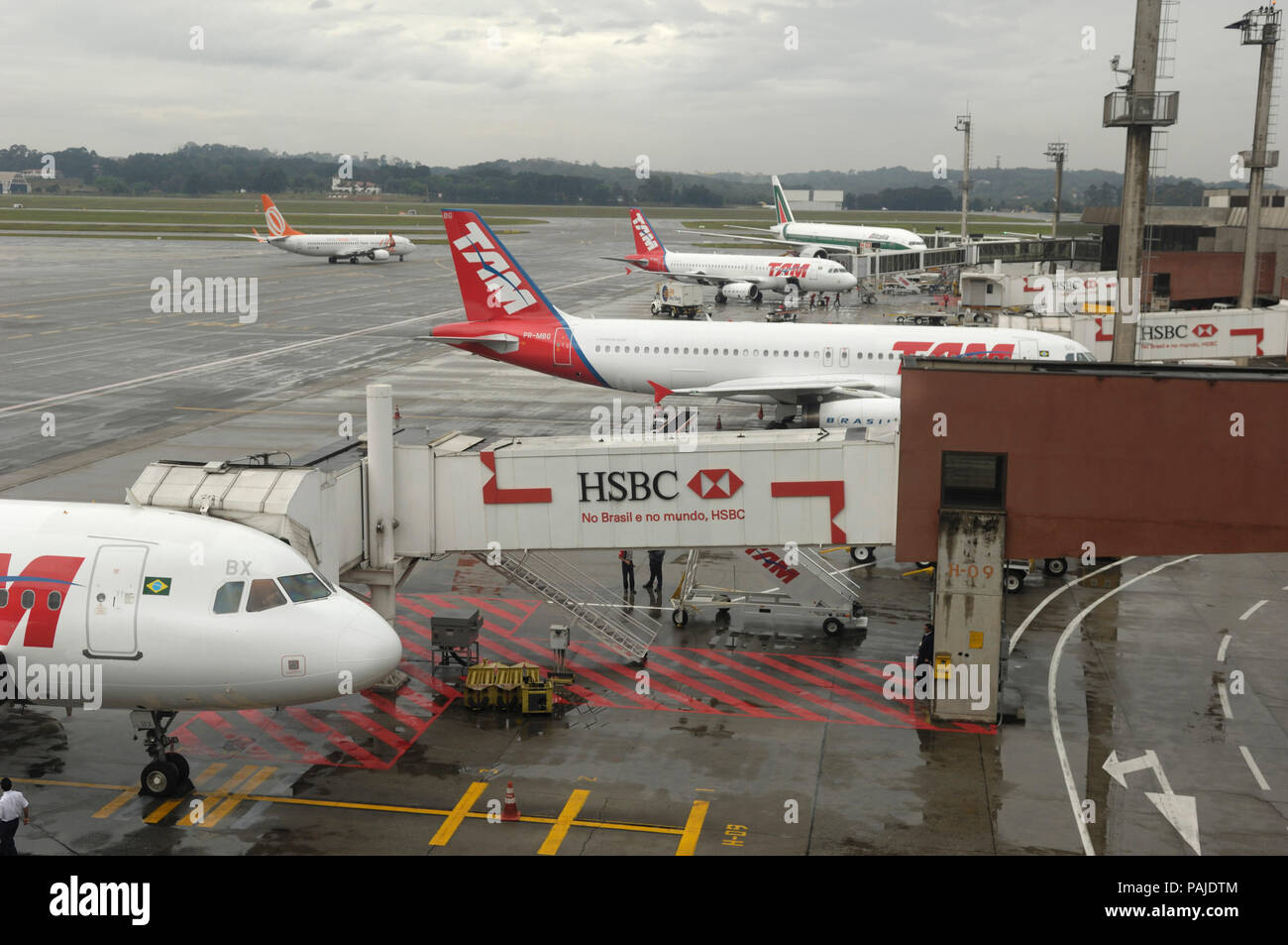 TAM Airbus A320-200s and Alitalia Boeing 777-200ER parked at terminal ...