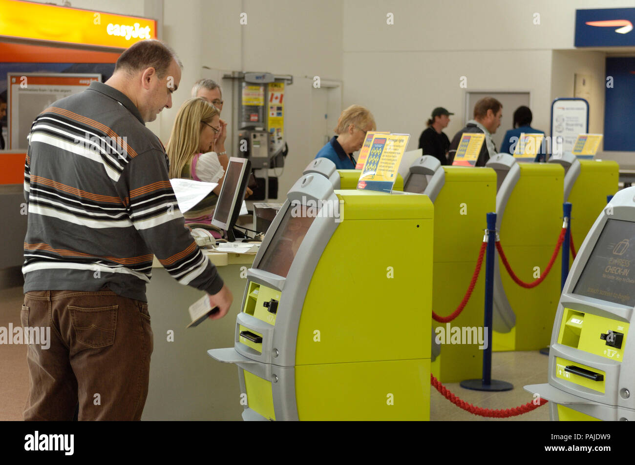 passengers checking-in at British Airways self-service check-in kiosks ...