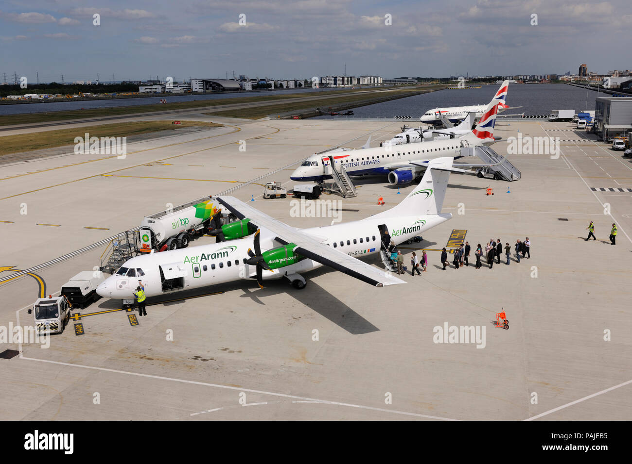 passengers with carry-on bags boarding an Aer Arann ATR 72-200 with Air ...