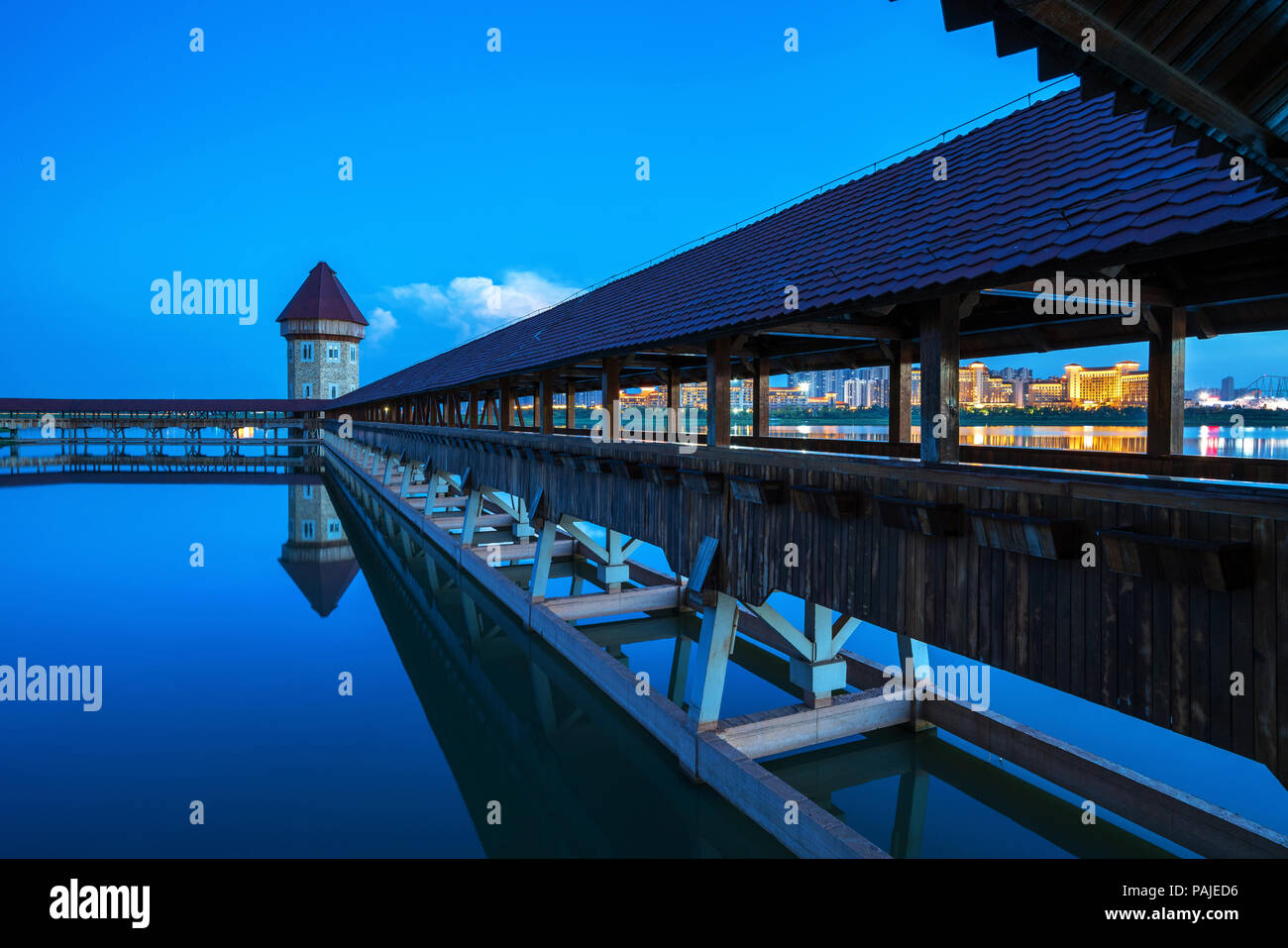 The European-style covered bridge is situated by the river, the ...