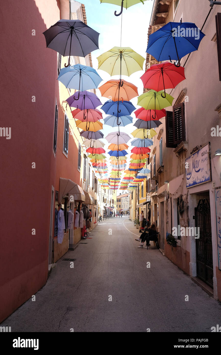 Umbrellas on a shopping street in the old town of Novigrad, Croatia ...
