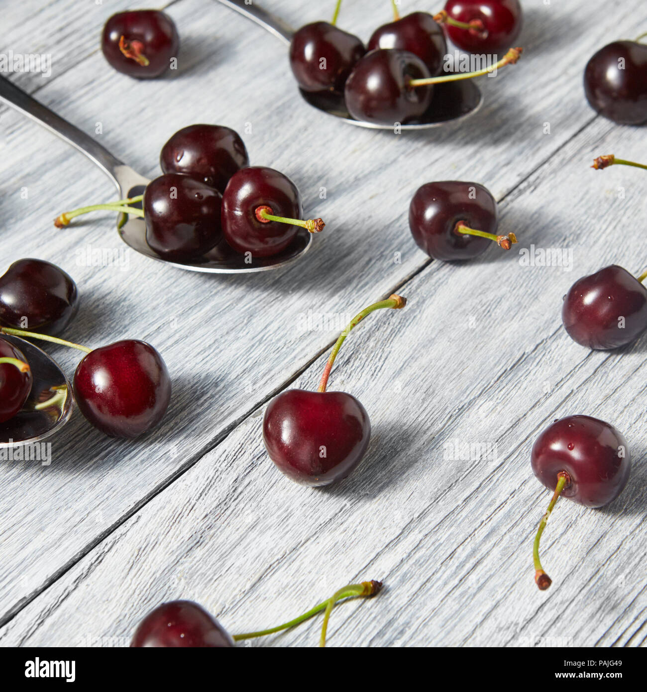Organic fresh cherries on wooden gray background Stock Photo - Alamy