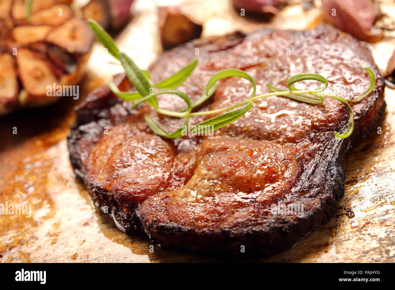 Fried grilled pork neck with garlic on rustic background Stock Photo ...