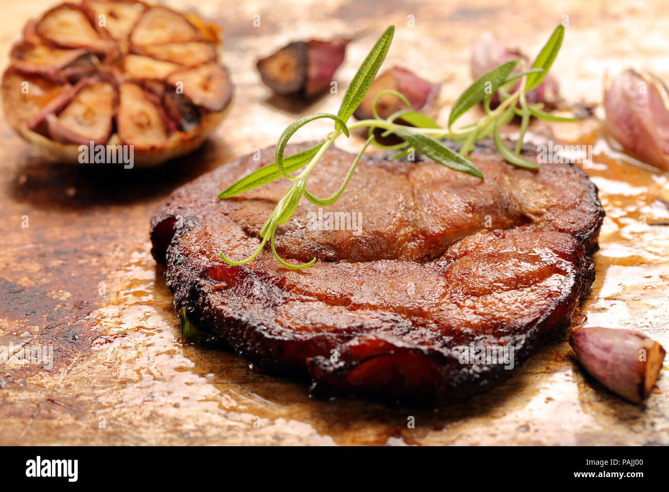 Fried grilled pork neck with garlic on rustic background Stock Photo ...