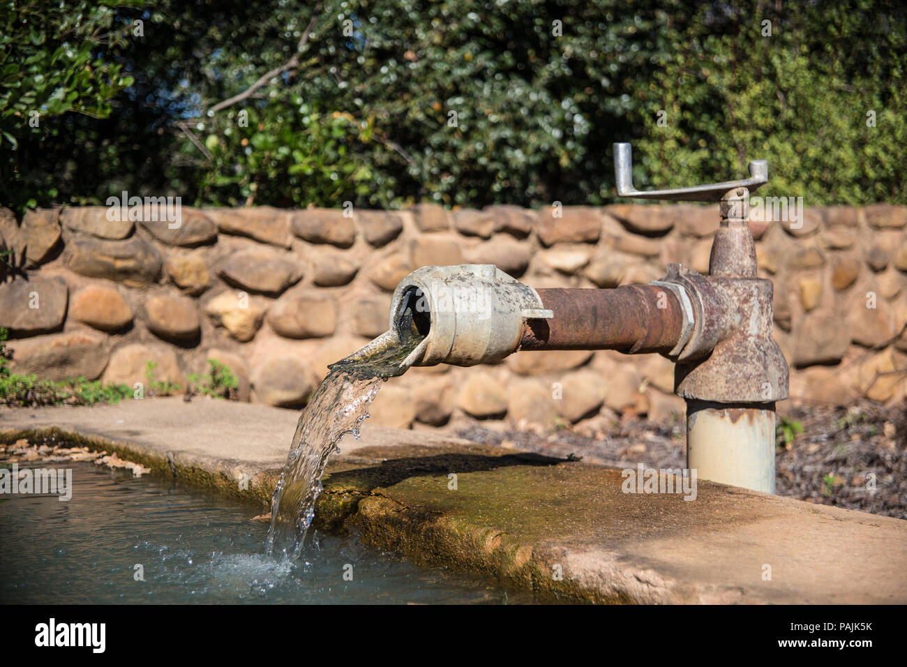 Water Running from a vintage rusty large tap Stock Photo - Alamy
