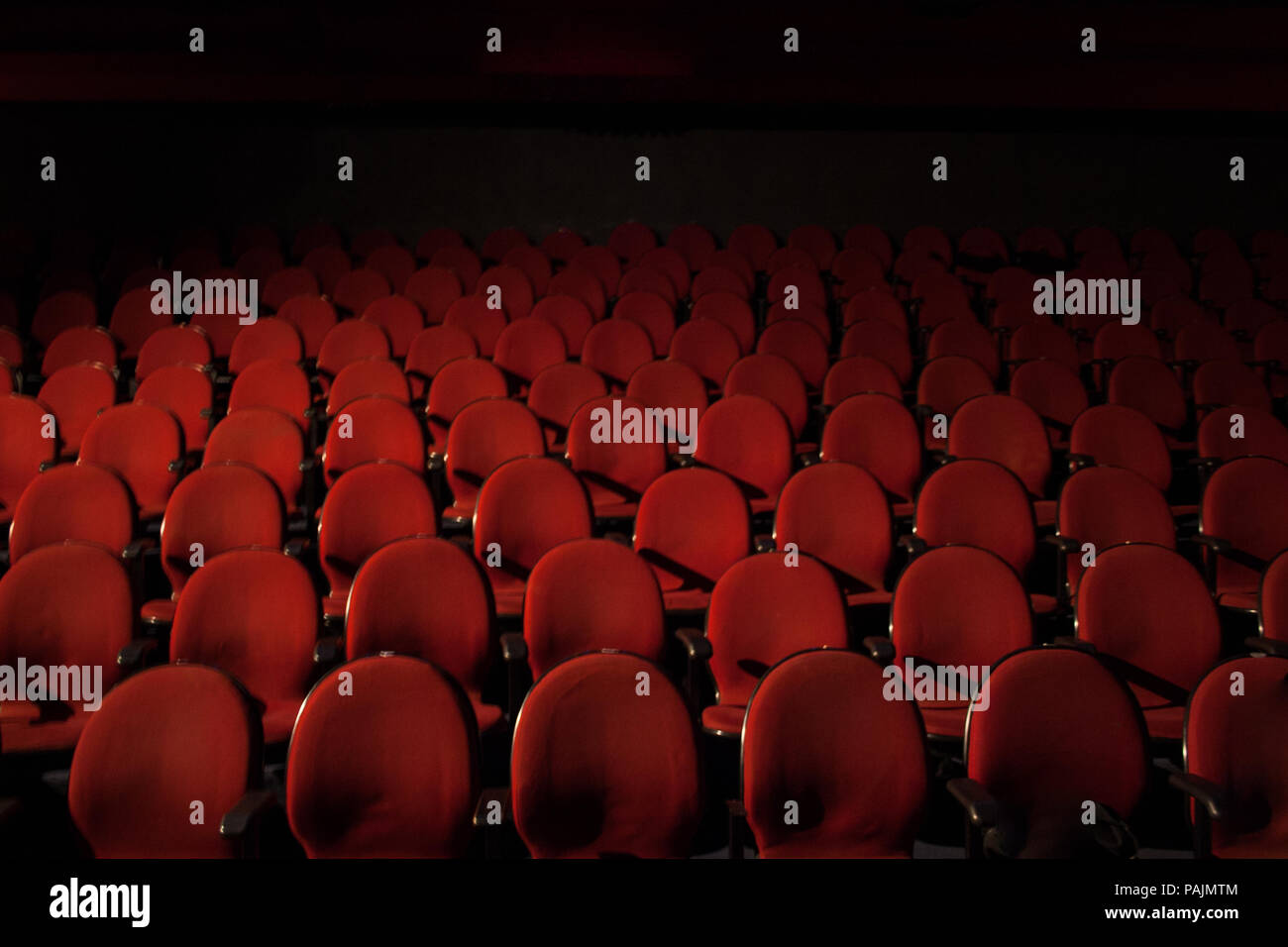 Red theatre seats with black dark shadow on the background Stock Photo ...