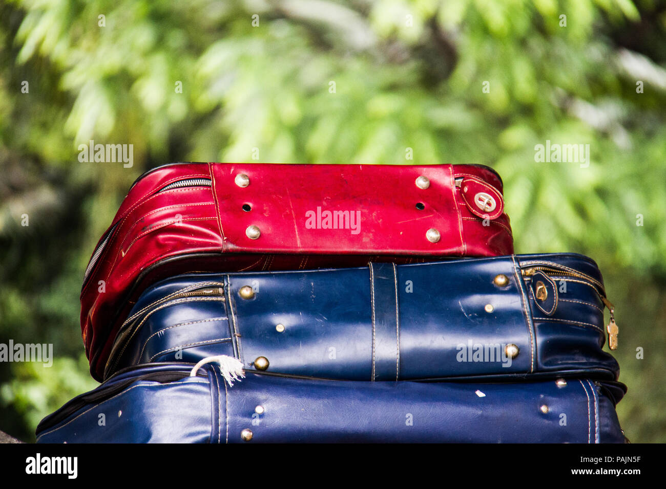 Vintage red and blue leather travel bags Stock Photo - Alamy