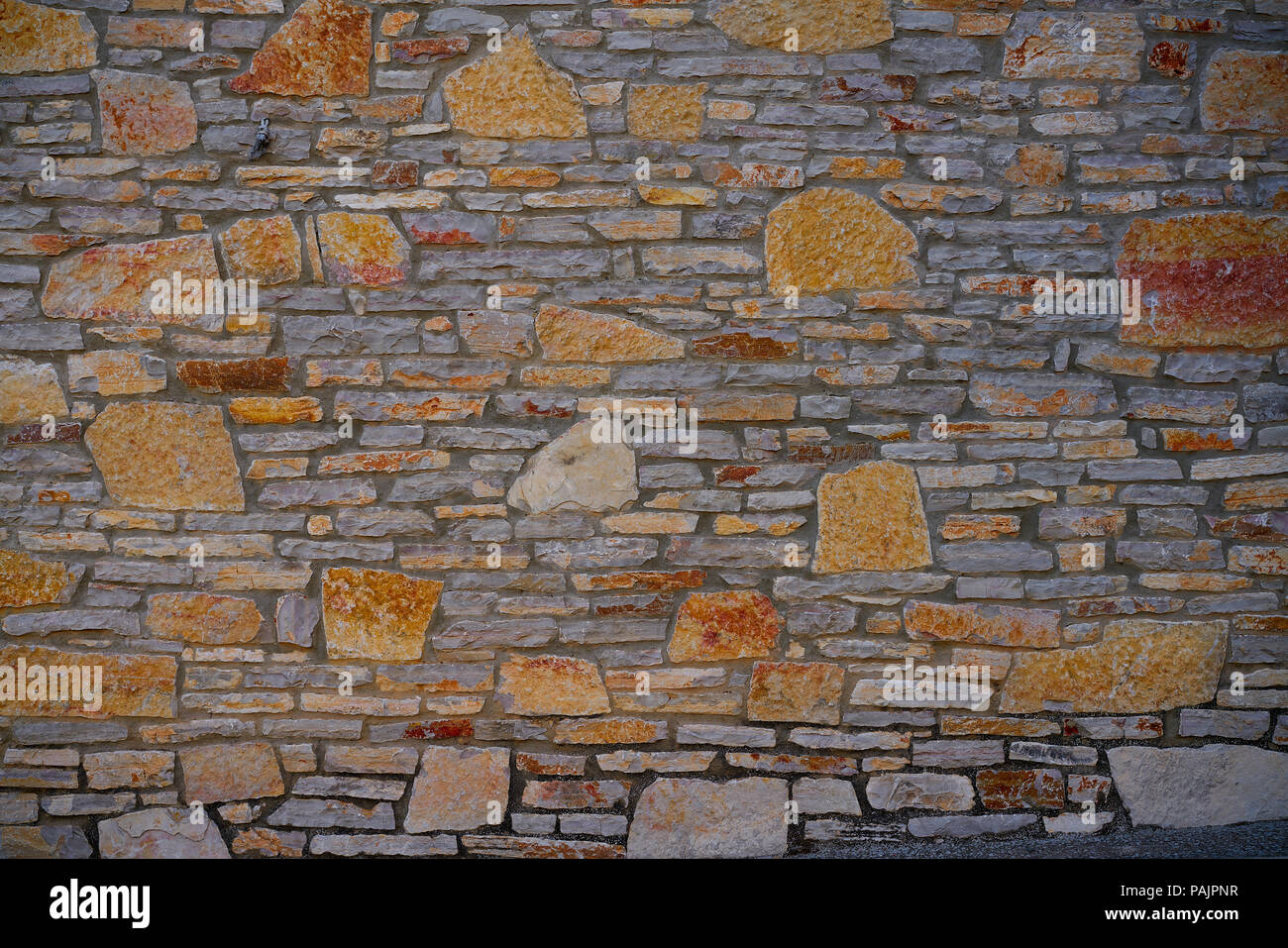 Masonry stone wall stonewall with different size stones Stock Photo - Alamy