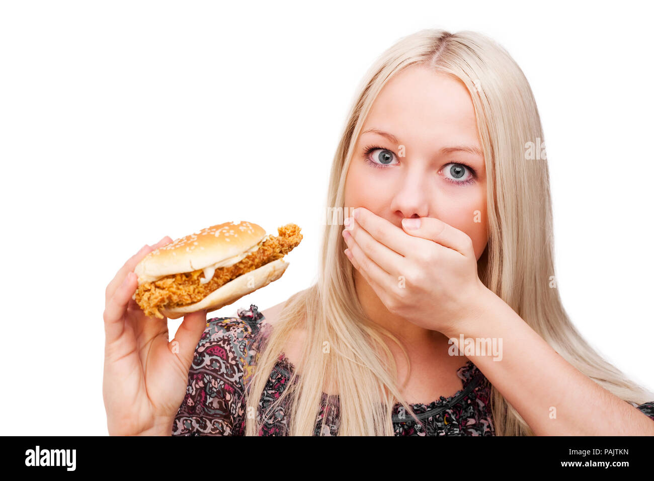 beautiful scared young blond woman with a burger, isolated against ...