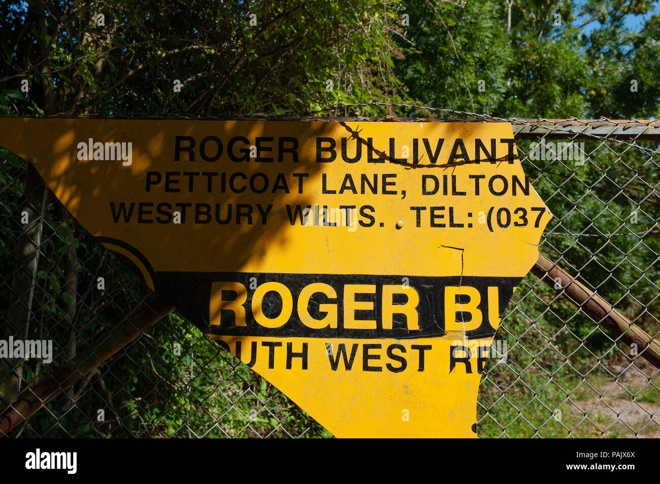 A broken sign indicating where this firm used to be based Stock Photo ...