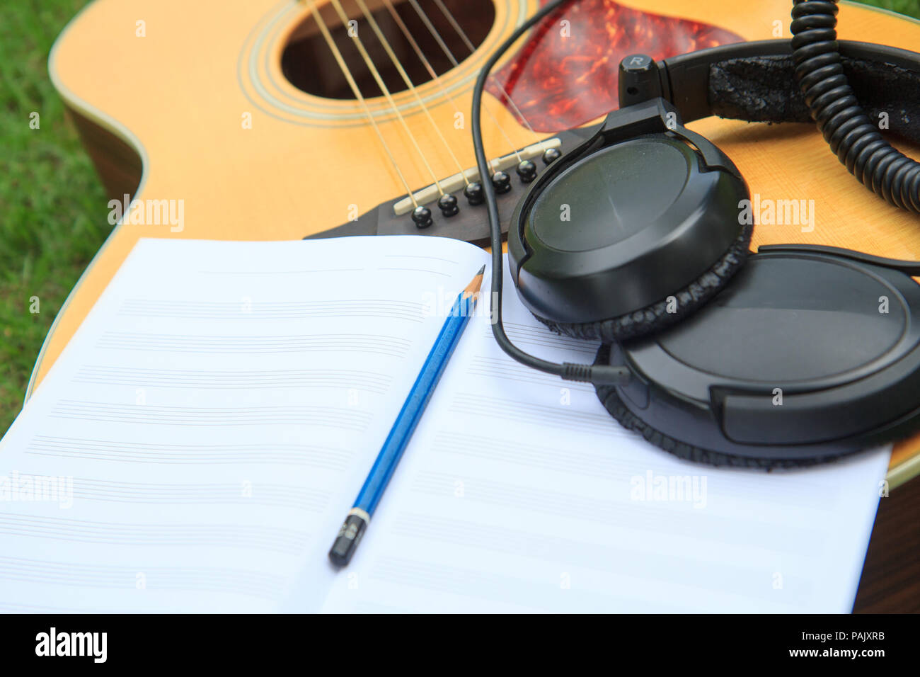 composer write note of song and use acoustic guitar for play Stock ...