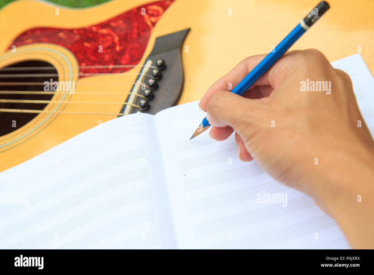 composer write note of song and use acoustic guitar for play Stock ...