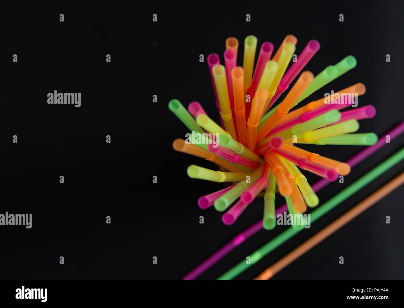 Closeup of colorful plastic straws swirl and line design as dangerous ...