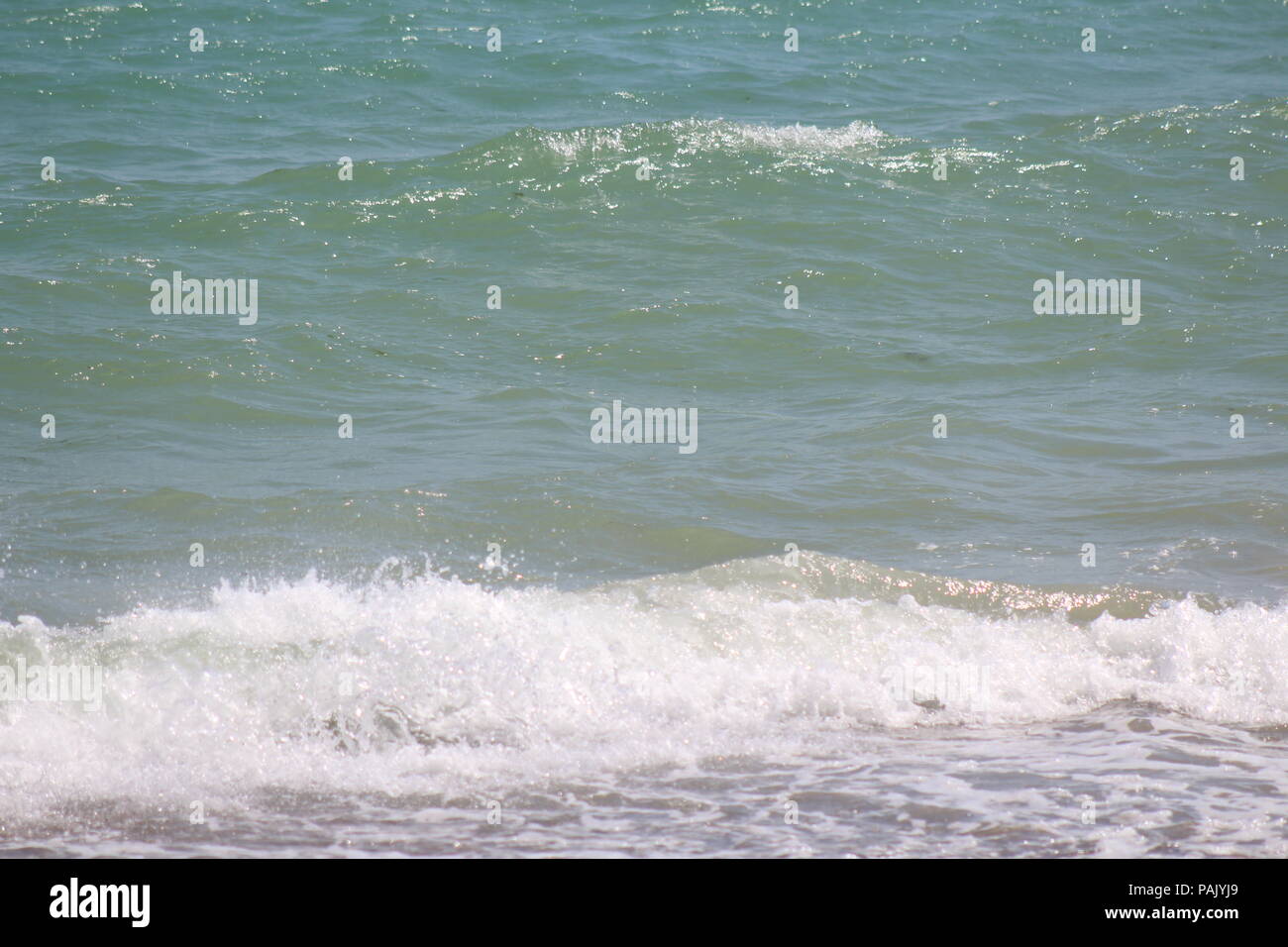 Tide coming in on pebble beach Stock Photo - Alamy