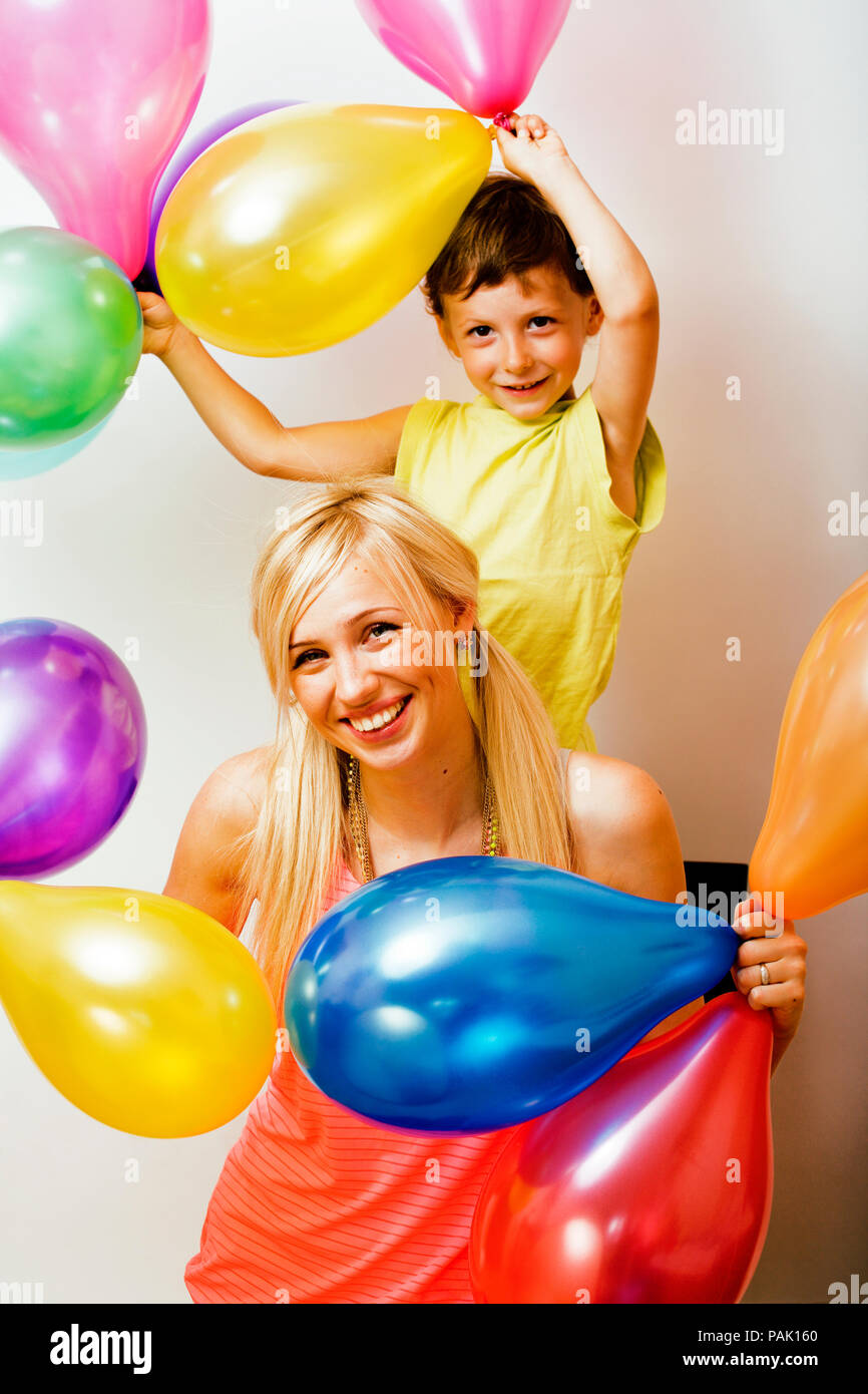 pretty real family with color balloons on white background, blon Stock ...