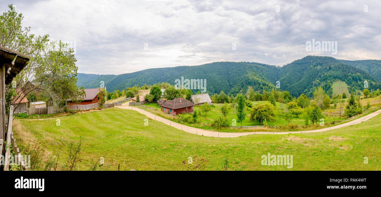 Wide perspective from a peak next to some rural cabins in Transylvania ...
