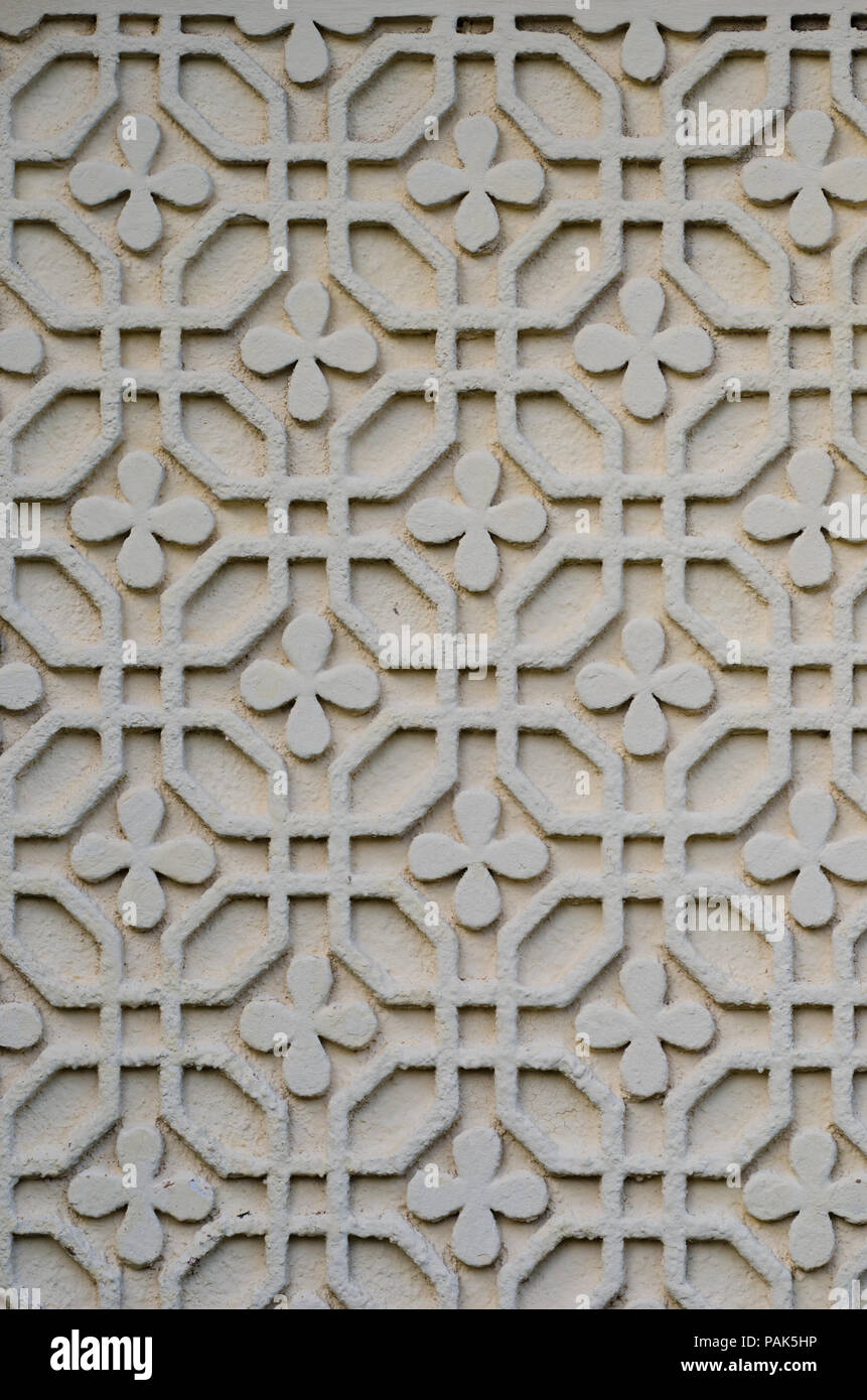 Floral and geometric stucco work on an exterior wall in romania with a ...
