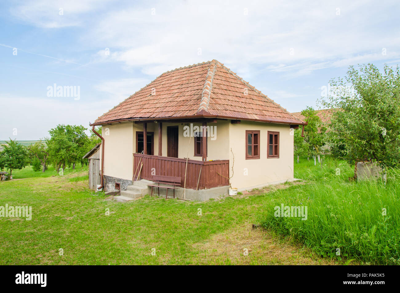 Traditional romanian rural house in Transylvania with fresh green grass ...