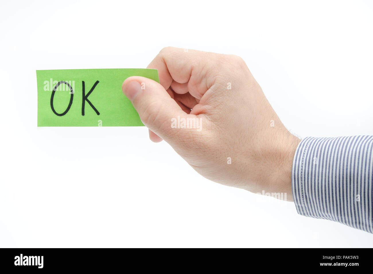 OK approval concept suggested by a green ticket in a business man's ...