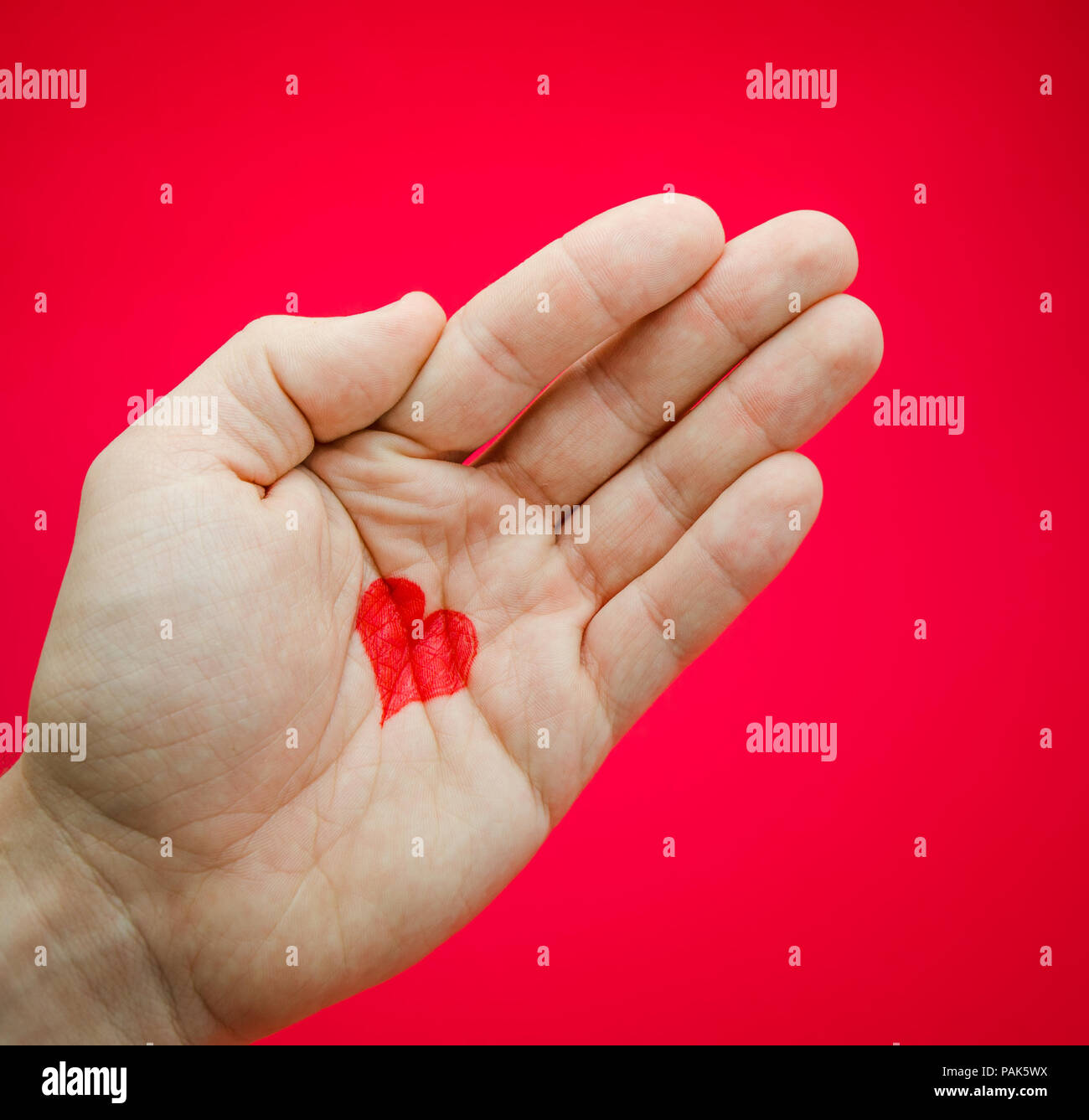 Keeping love safe suggested by a heart in a closed palm protecting it ...