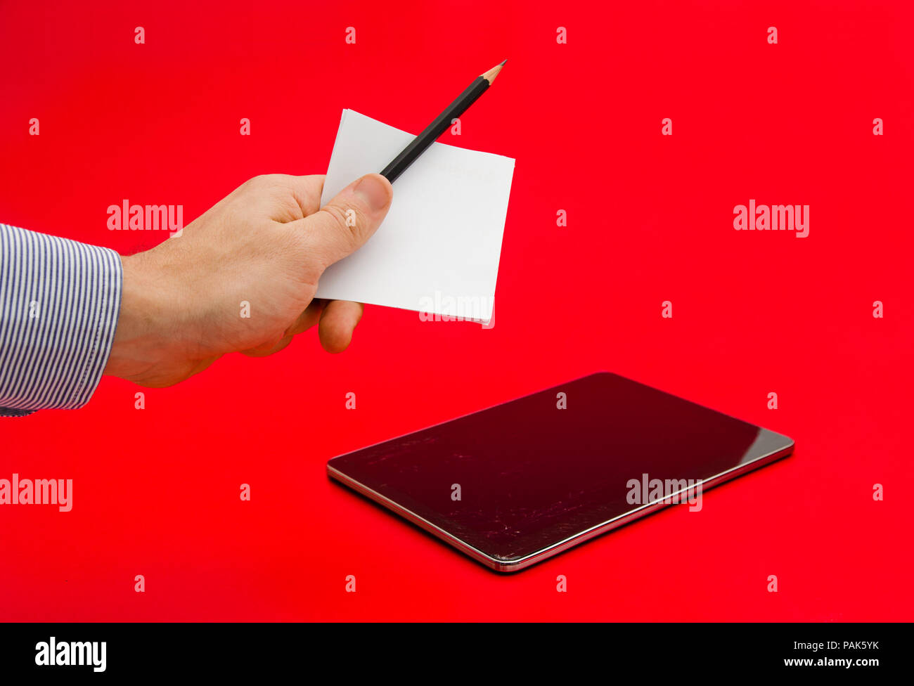 Paper notes and a pencil in comparisson with a modern high tech ...