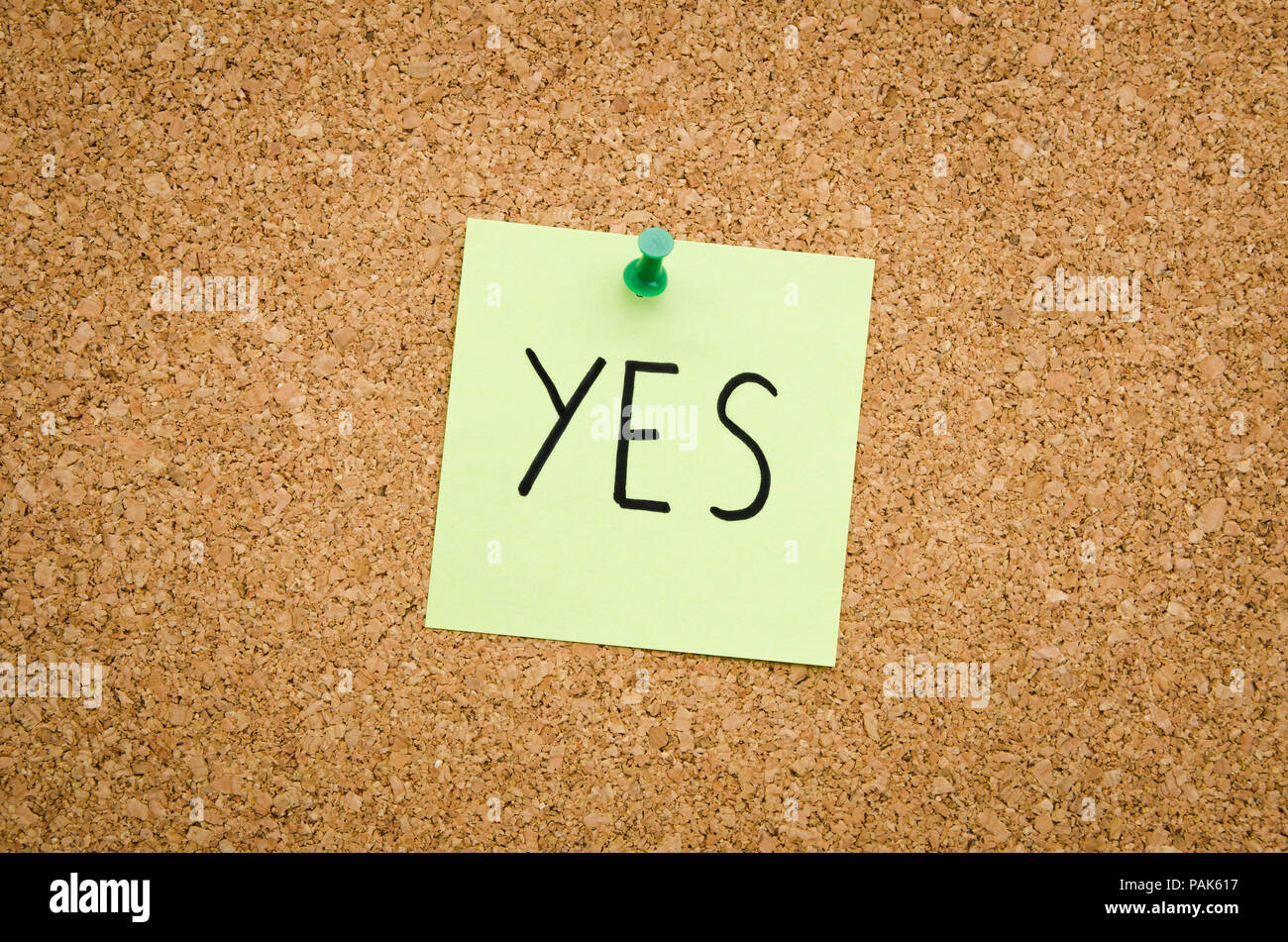 YES green note pinned to a bpard suggesting afirmative, positive, right ...