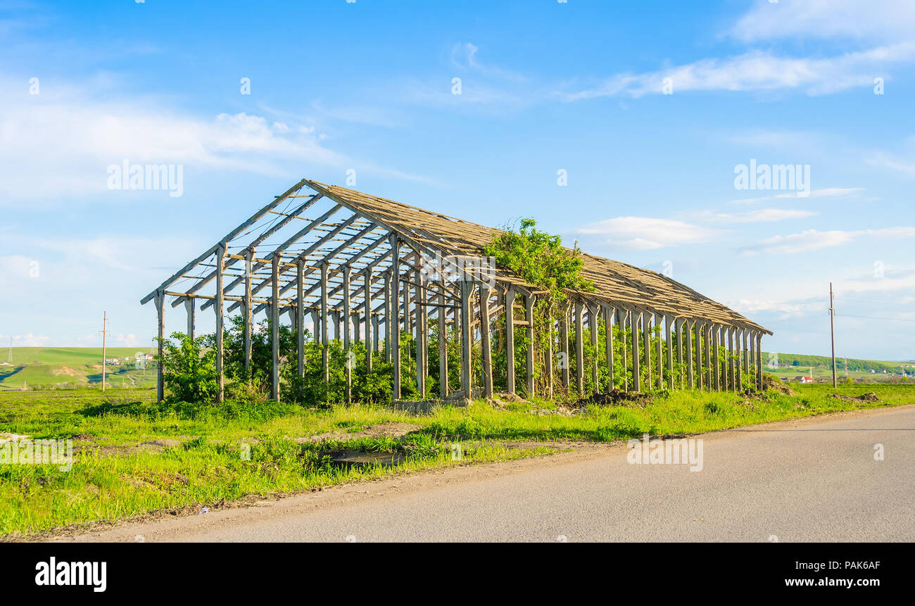 Abandoned wrecked and ruined agriculture structure still standing on ...