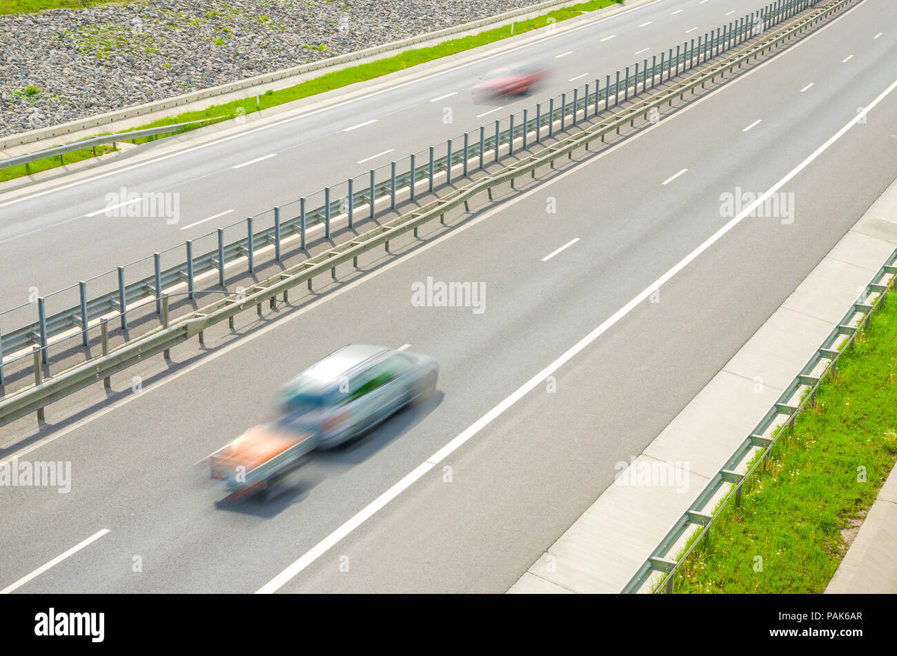 Speeding cars on a highway motorway road in a view frome above in a ...