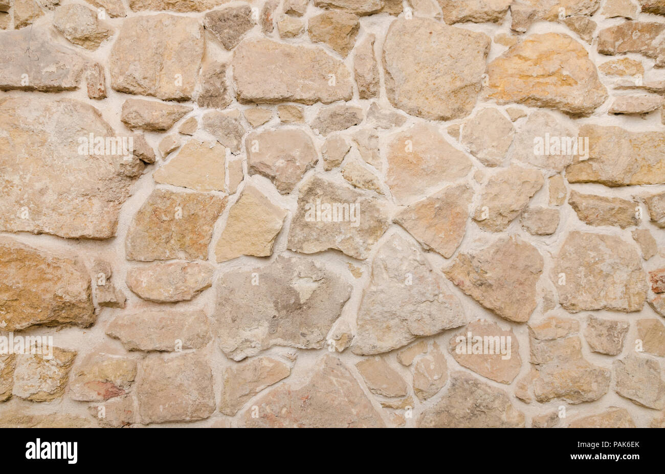 Ancient river stone wall texture with a warm look Stock Photo - Alamy