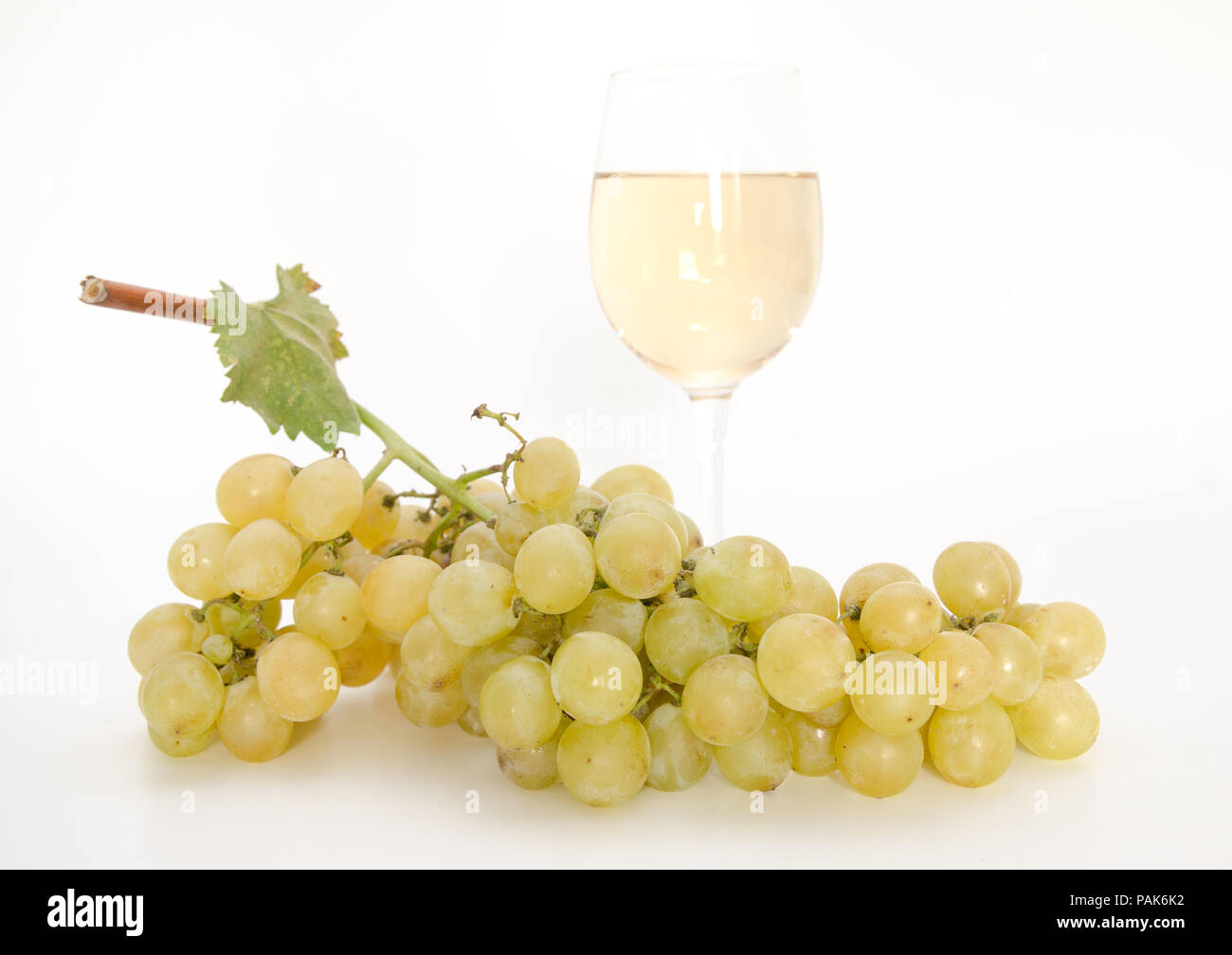 Yellow wine with grapes and vine leaf Stock Photo - Alamy