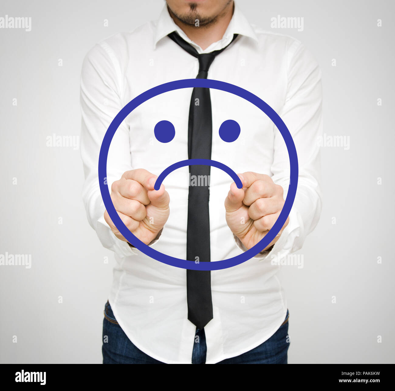 A blue sad face being drawn by a business man in a white shirt with a ...