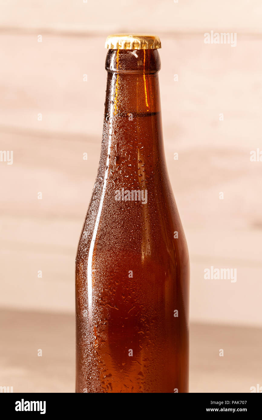 a bottle of amber beer with its capsule Stock Photo - Alamy