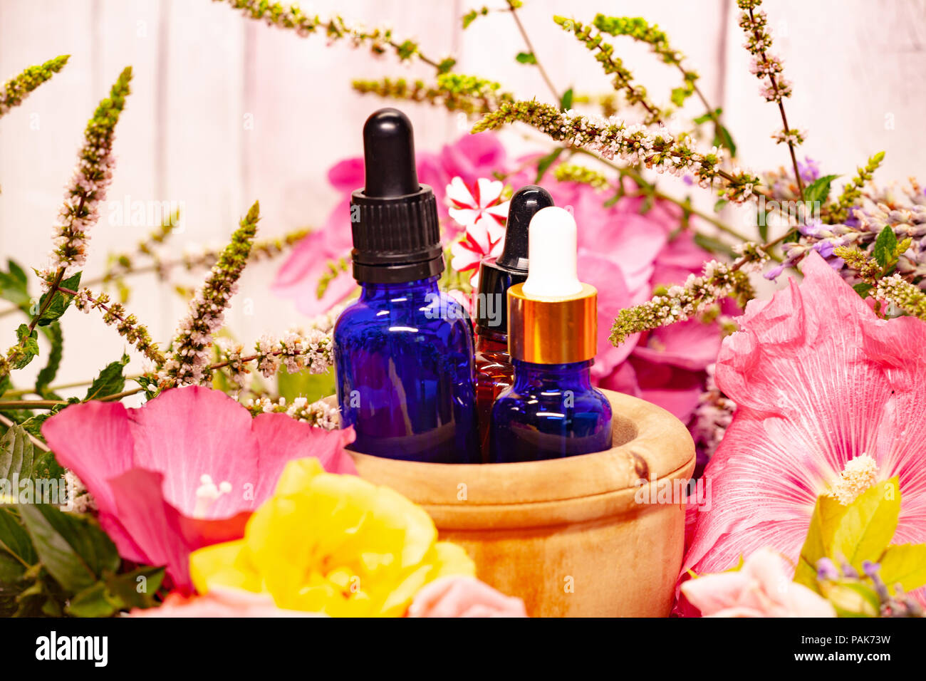 flowers and bottles of essential oils for aromatherapy Stock Photo - Alamy