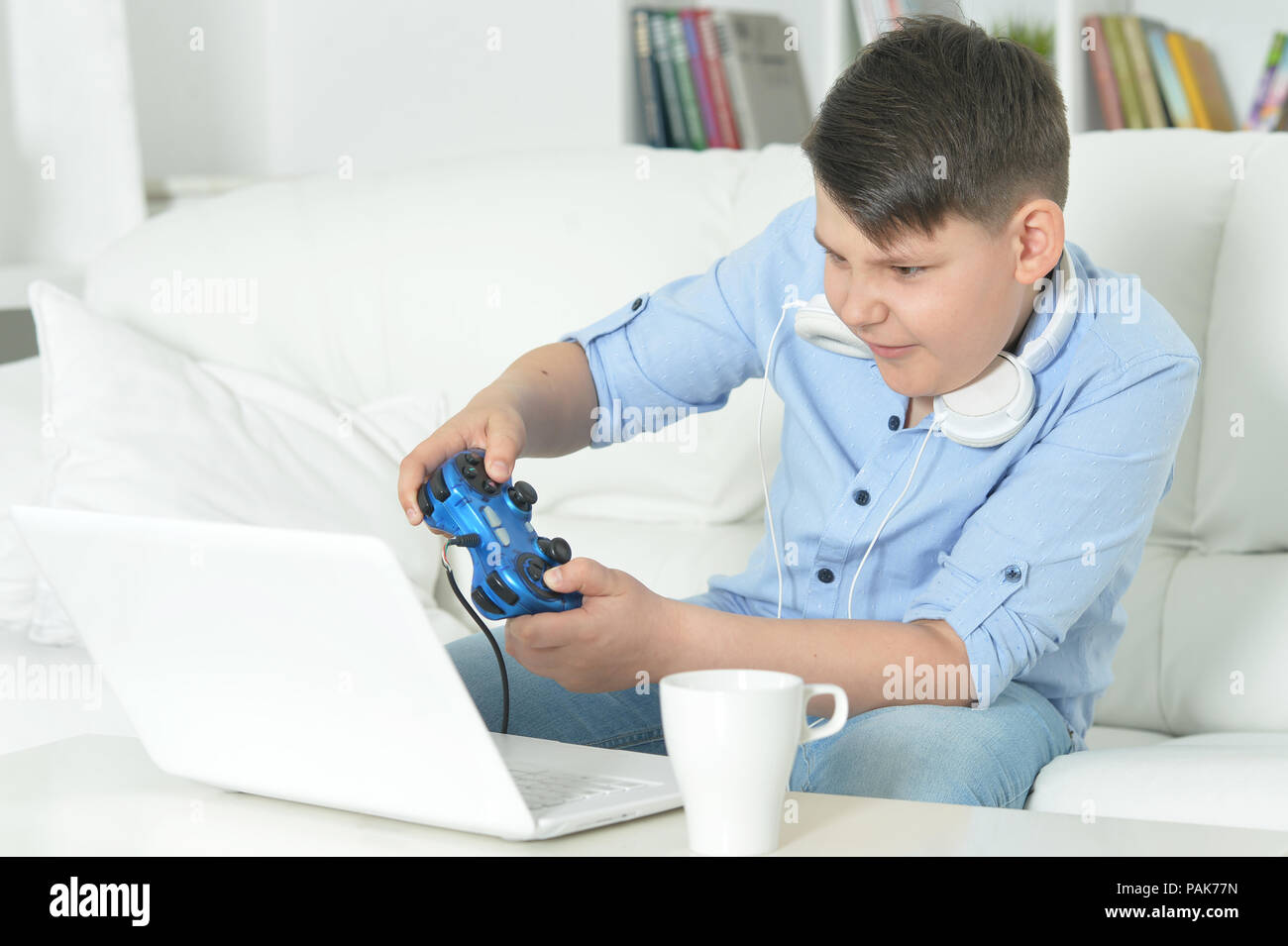 boy playing computer game with laptop Stock Photo - Alamy
